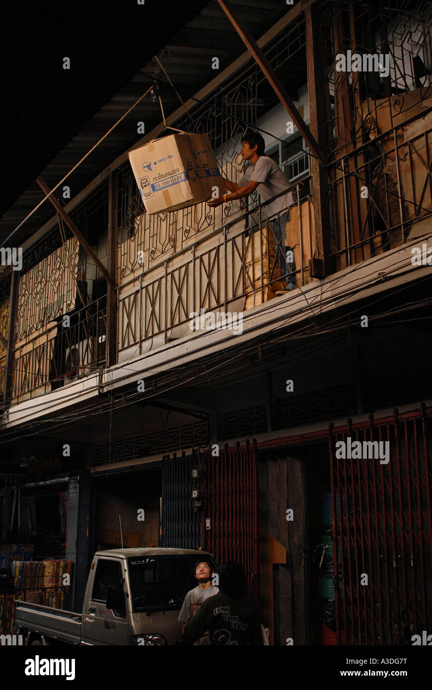 Loading and unloading Transporting a heavy boxed load by pulley from a ...