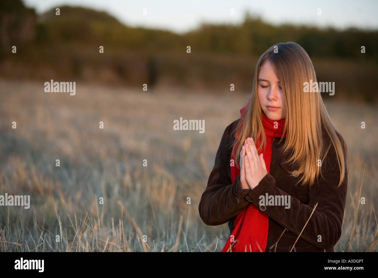 A teenage girl praying Stock Photo - Alamy