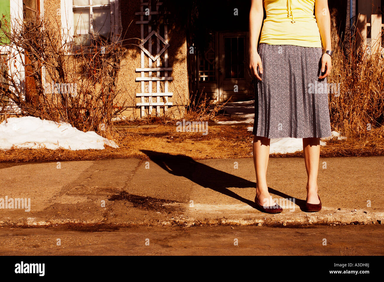 Woman waiting on the curb Stock Photo - Alamy
