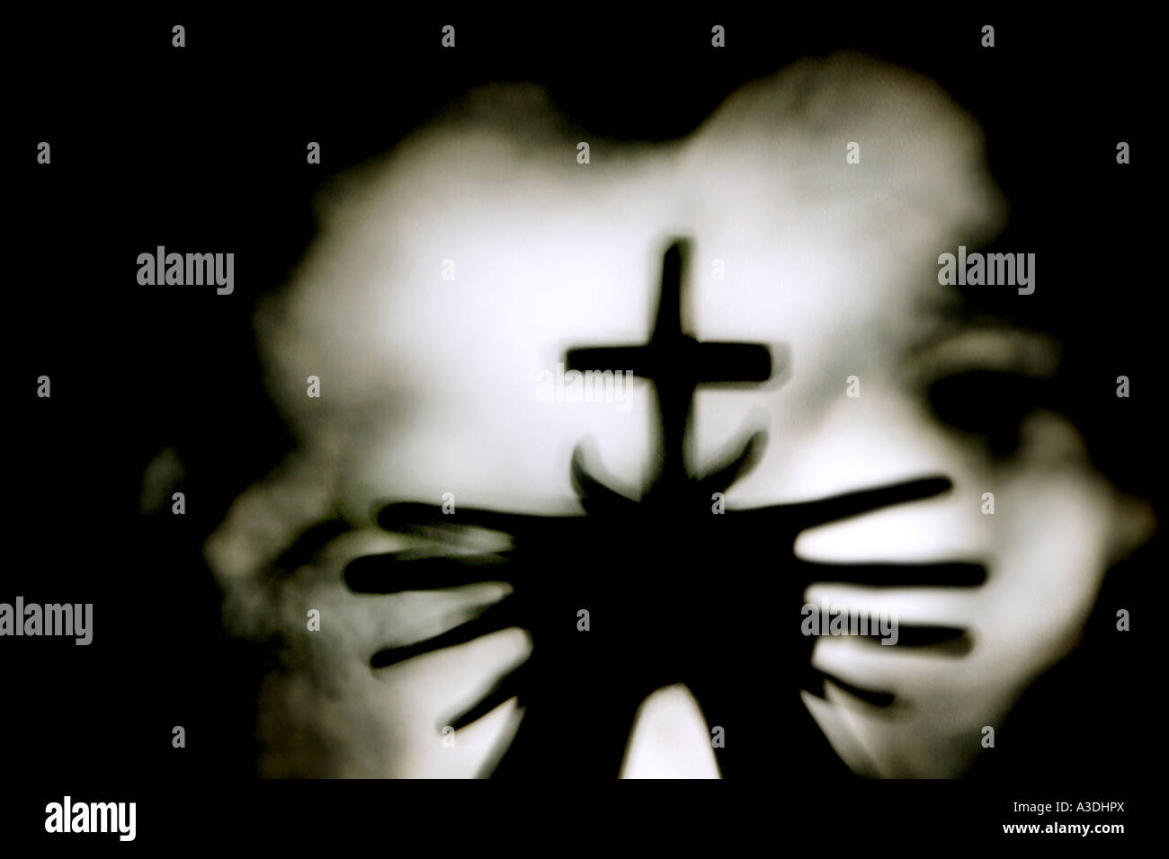 Hands on cross Stock Photo - Alamy