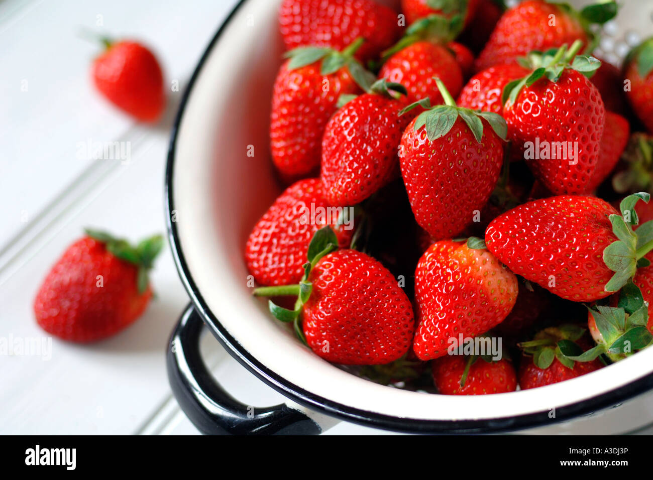 Strawberries in enamel colander Stock Photo - Alamy