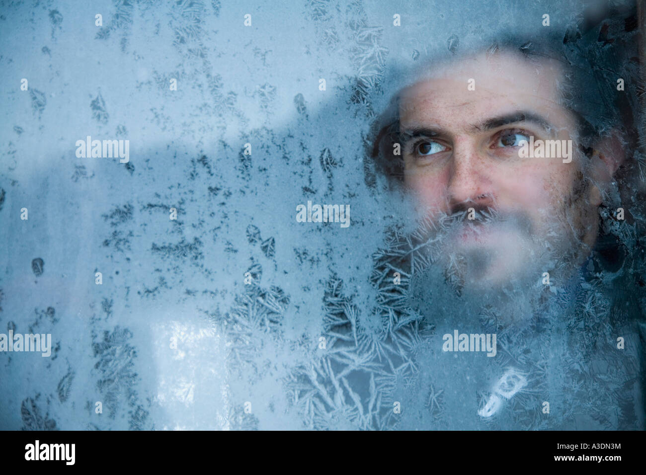 Man looking through frosted glass Stock Photo - Alamy