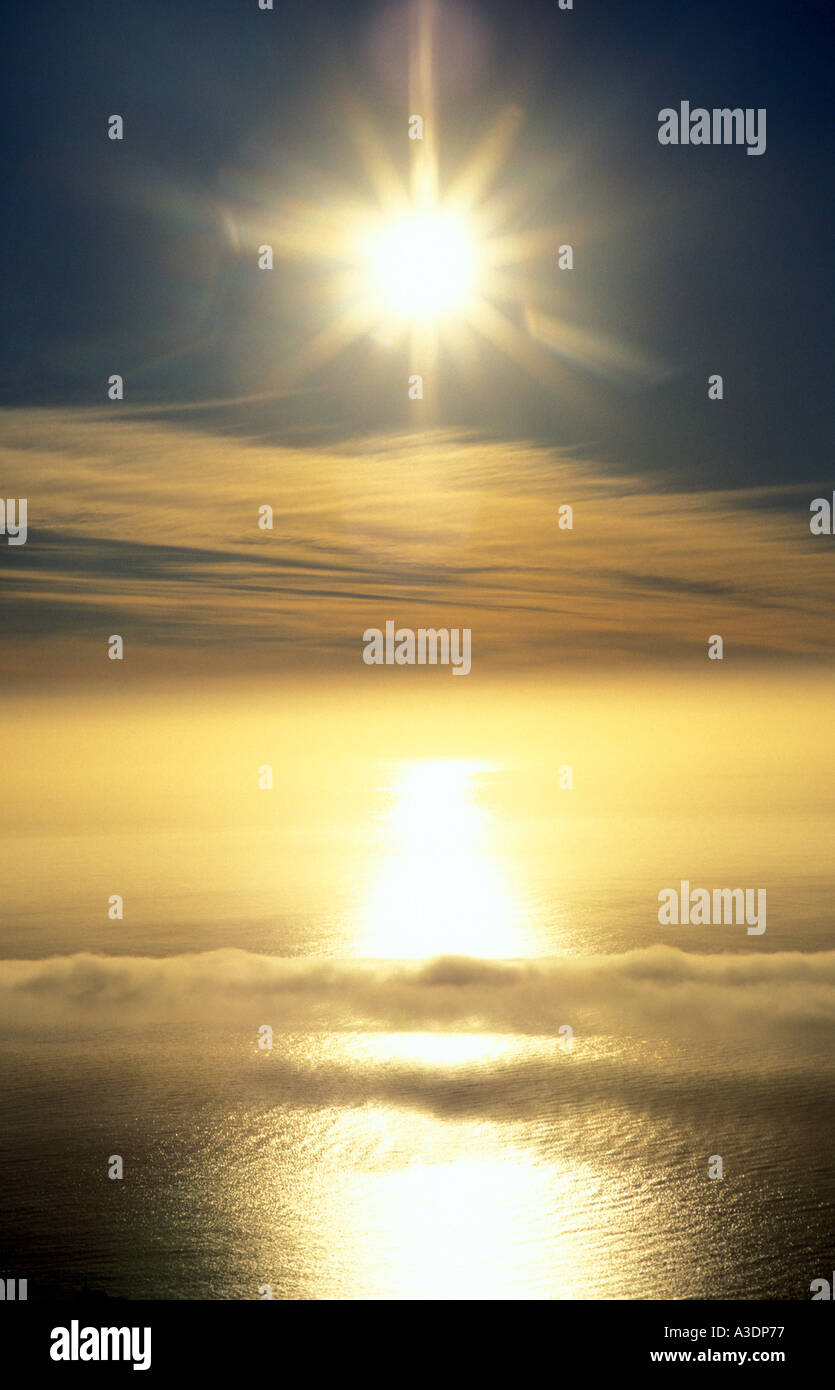Sun begining to set in a dramatic cloudscape over the Atlantic ocean ...