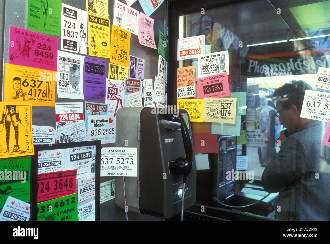 Inside of a London telephone box covered with prostitute cards Stock ...