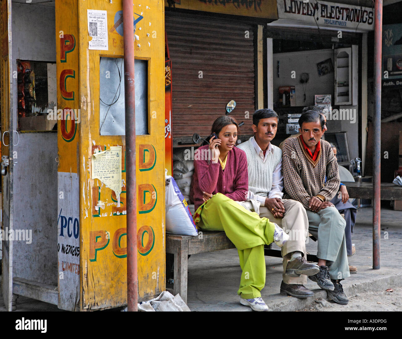 Woman in front of a telephone box, using her mobile phone, Maryog ...