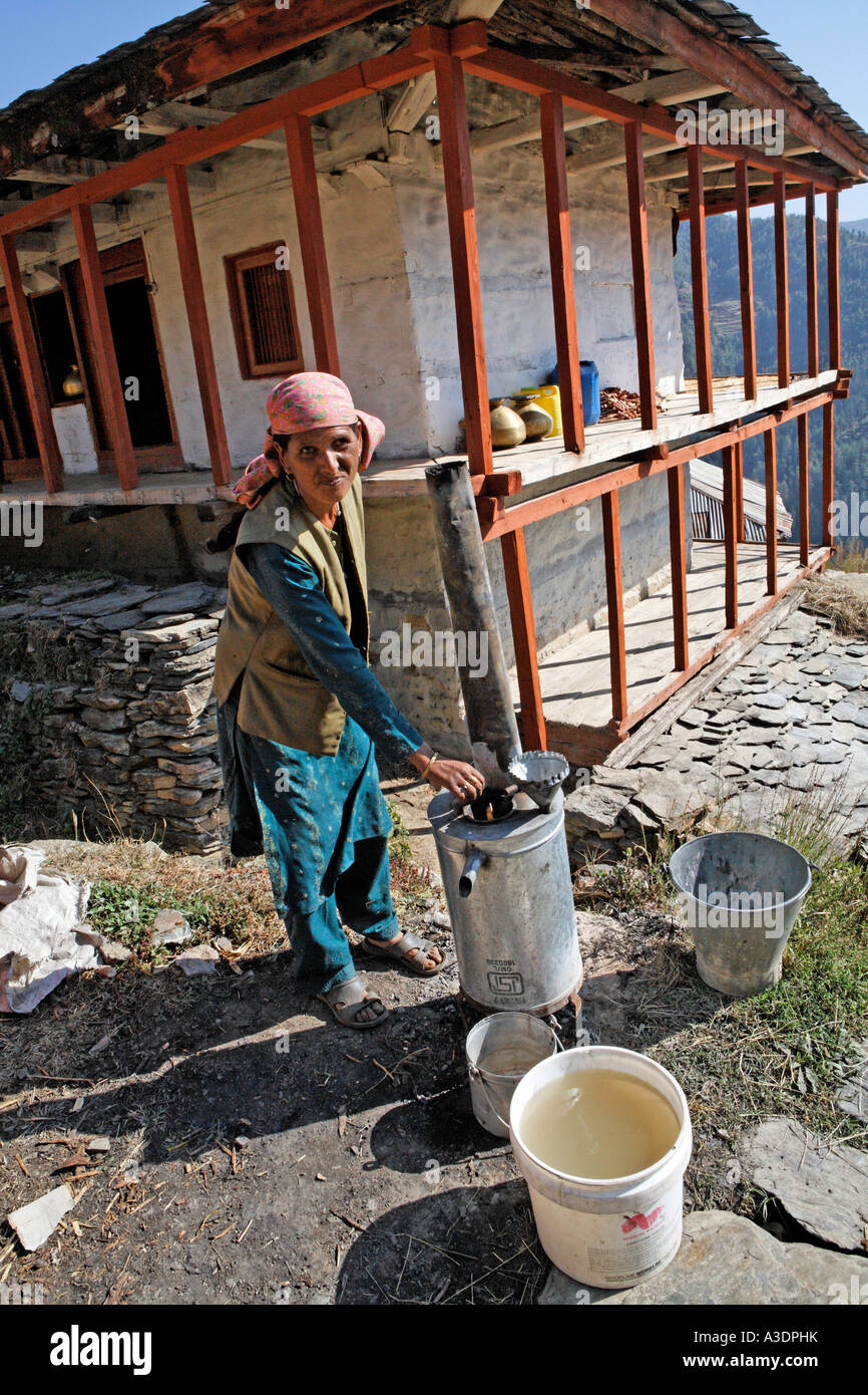 Woman boiling water in front of her house, Matiyama, Himachal Pradesh ...