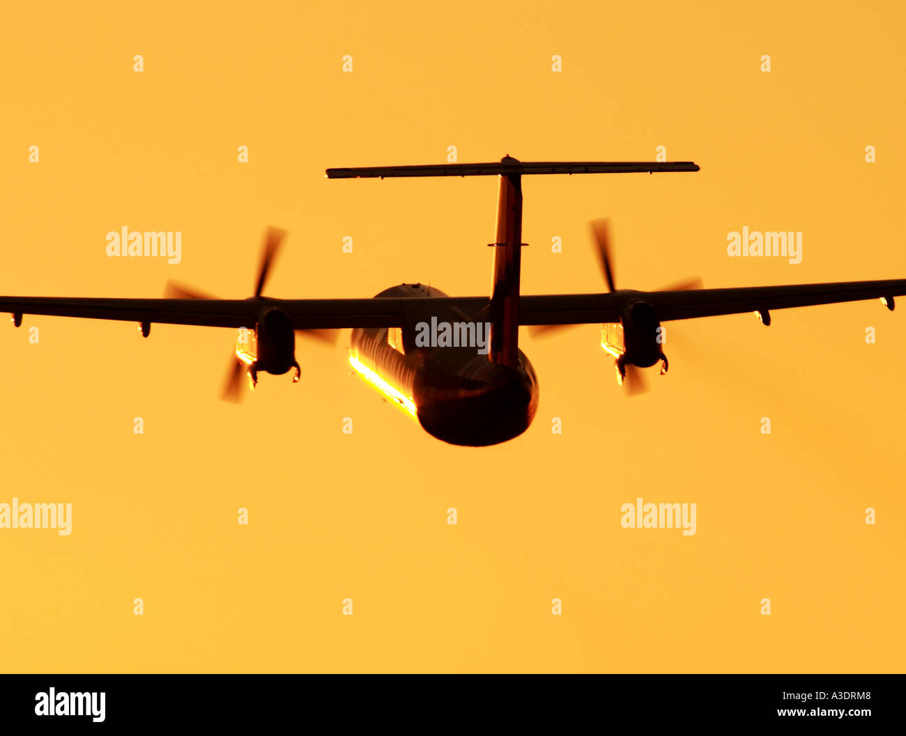British Airways BA Dash De Havilland 8 airbourne during vivid orange ...