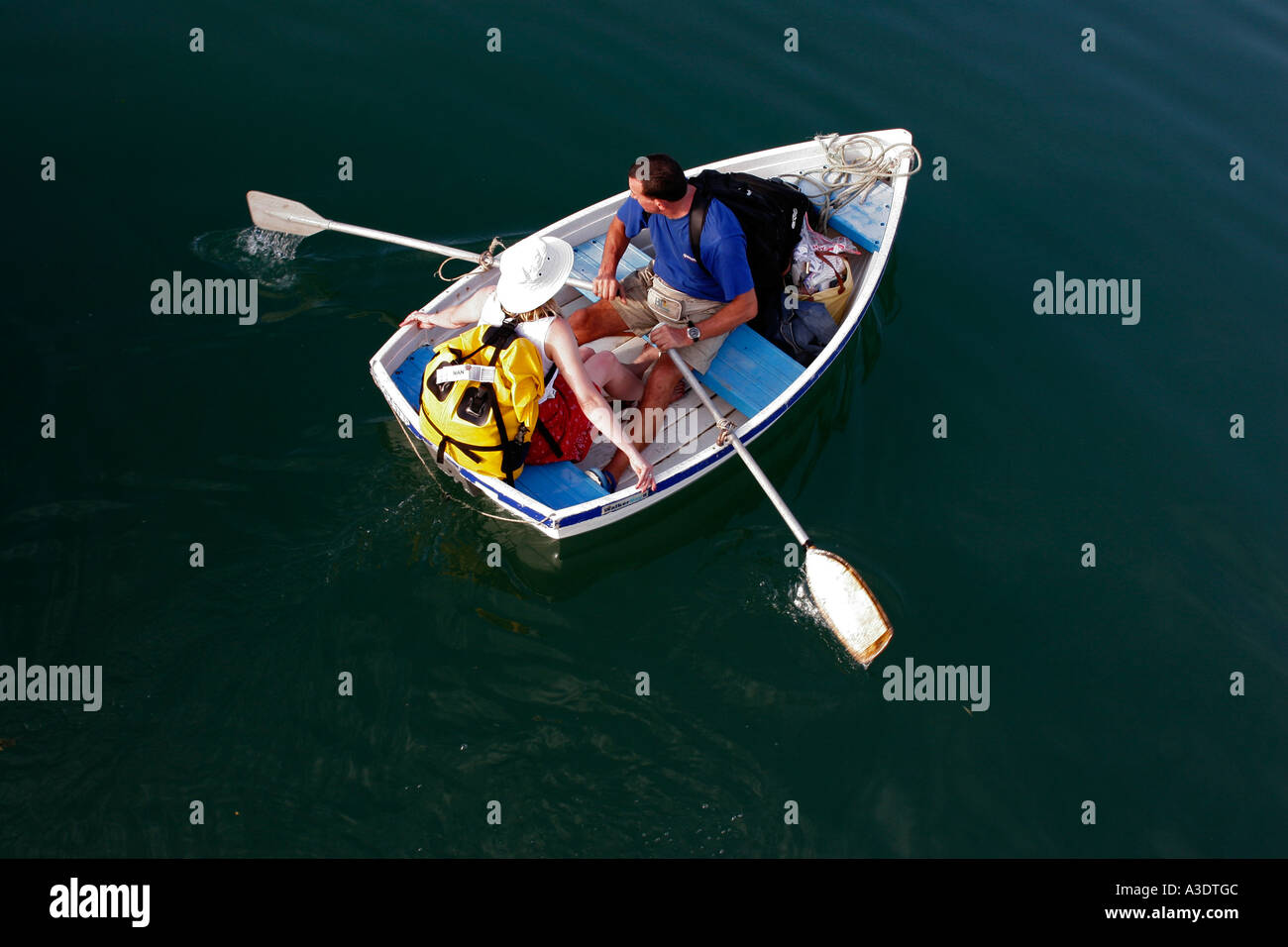 Man rowing small dingy with woman passenger seen from above, Fiji Stock ...
