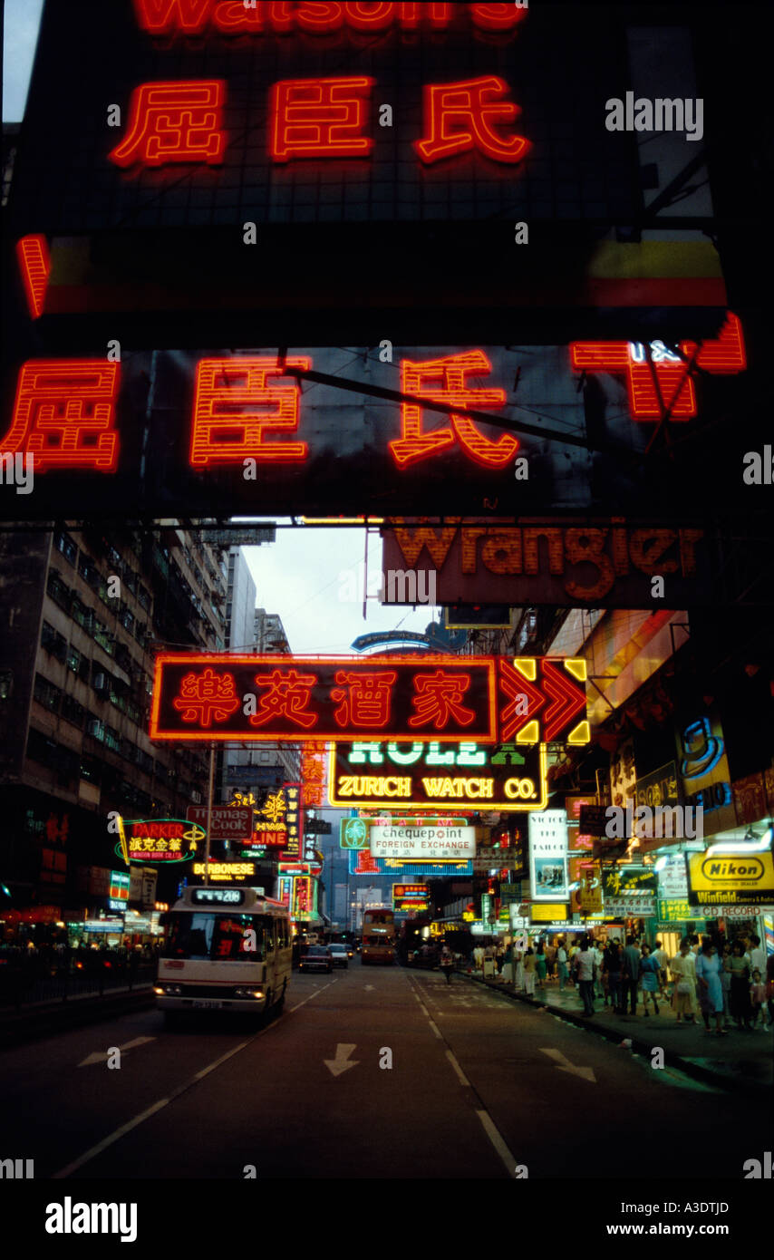 Nathan Road at dusk with neon advertising signs, crowded pavements ...