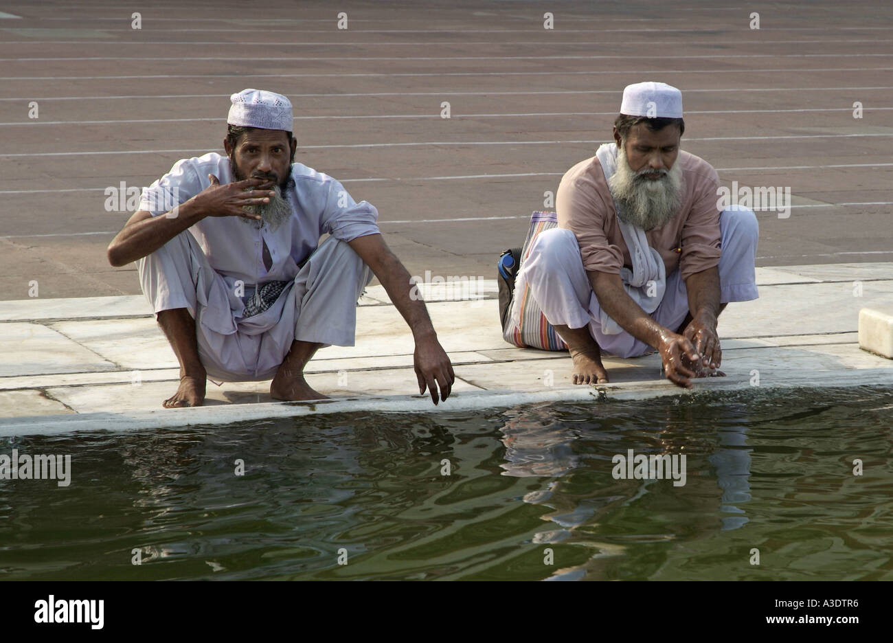 Men washing before prayer at the Jami Masjid Mosque in Delhi India ...
