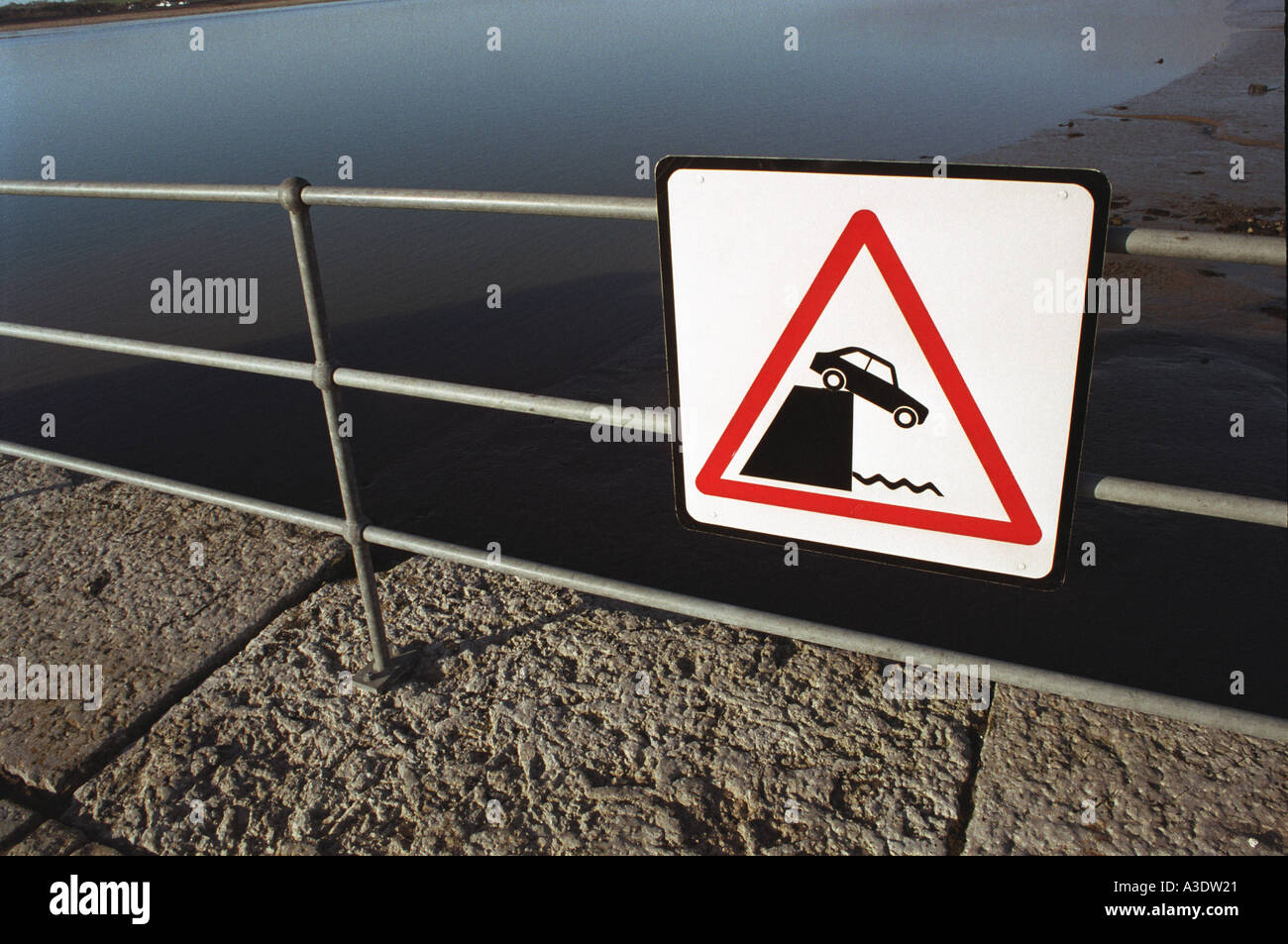 danger of cars falling into sea warning Stock Photo - Alamy