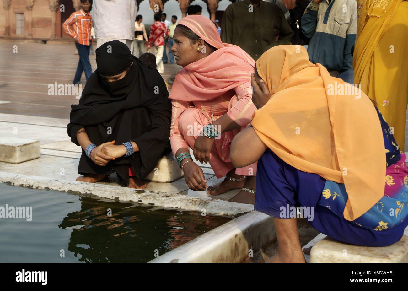 Women washing before prayer at the Jami Masjid Mosque in Delhi India ...