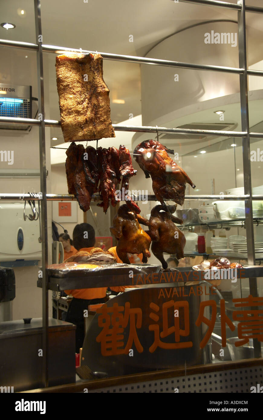 Cooked Peking ducks hanging in the window of a chinese restaurant ...