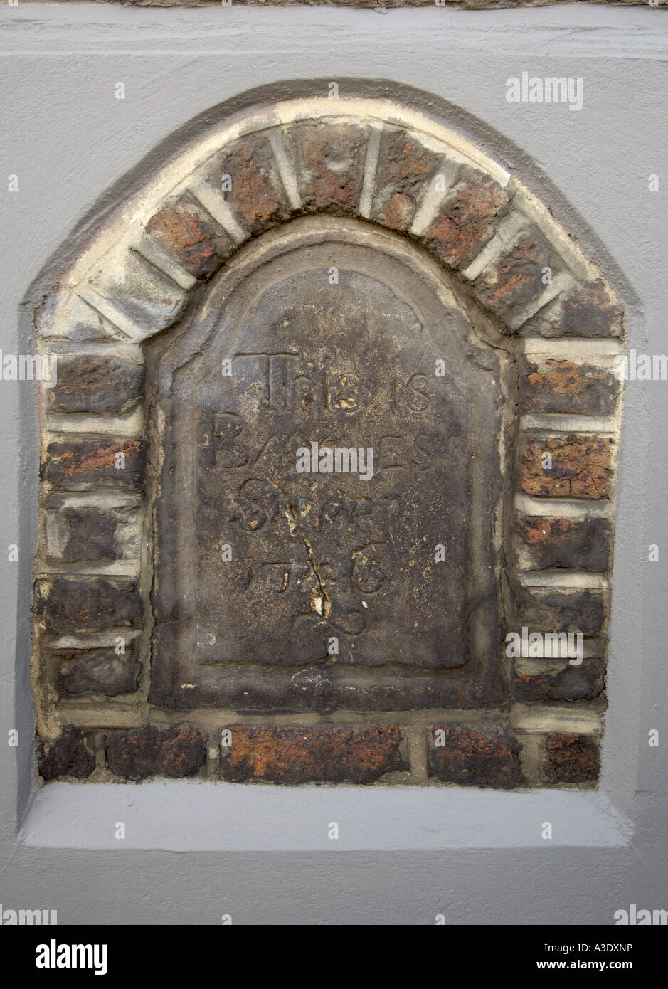 Old carved stone street sign saying "This is Baynes Street 1746" on the ...