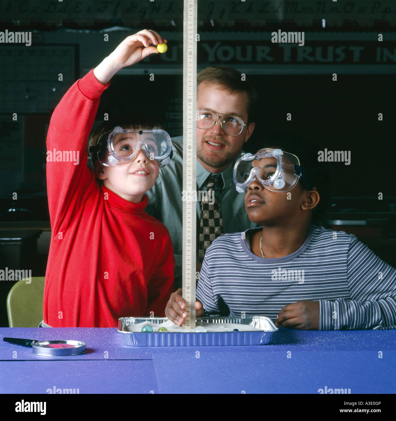 Teacher And Students Performing Science Experiment In Elementary School ...