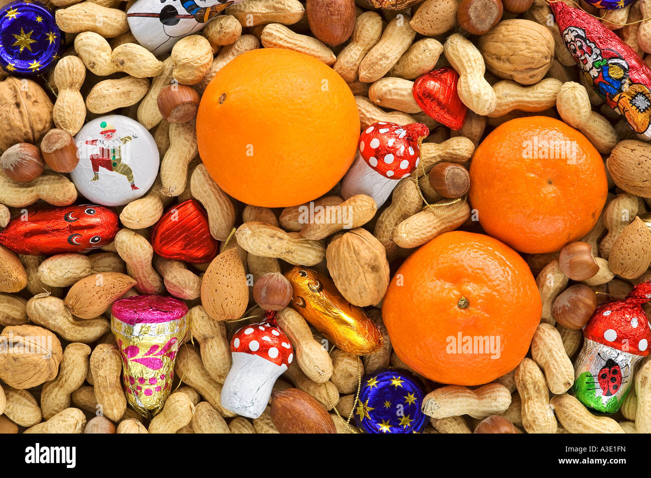 Different sorts of nuts with christmas chocolate and tangerines Stock ...