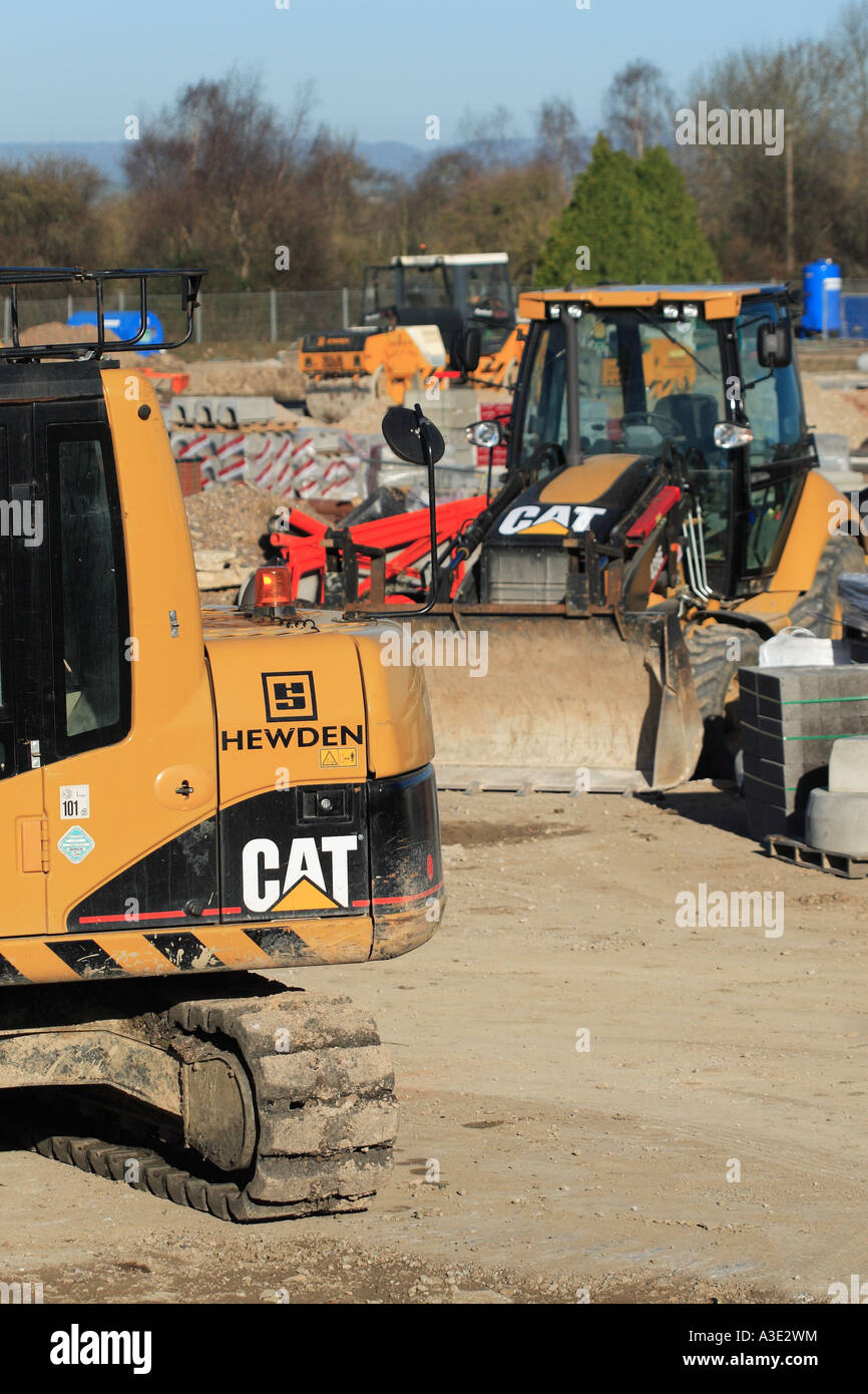 Construction building site yellow painted mechanical diggers and ...