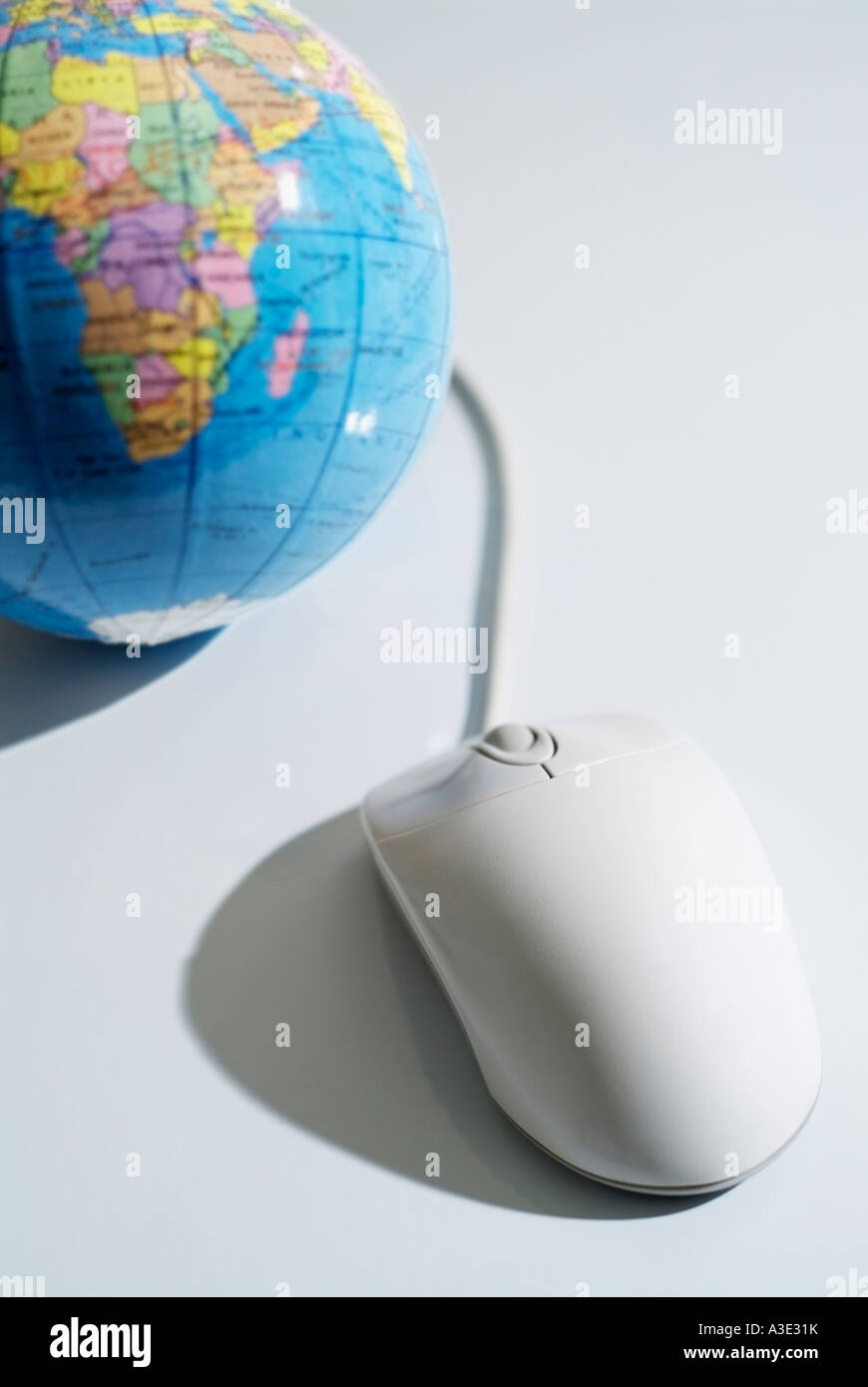 Computer Mouse Linked to a Globe of the World Stock Photo - Alamy