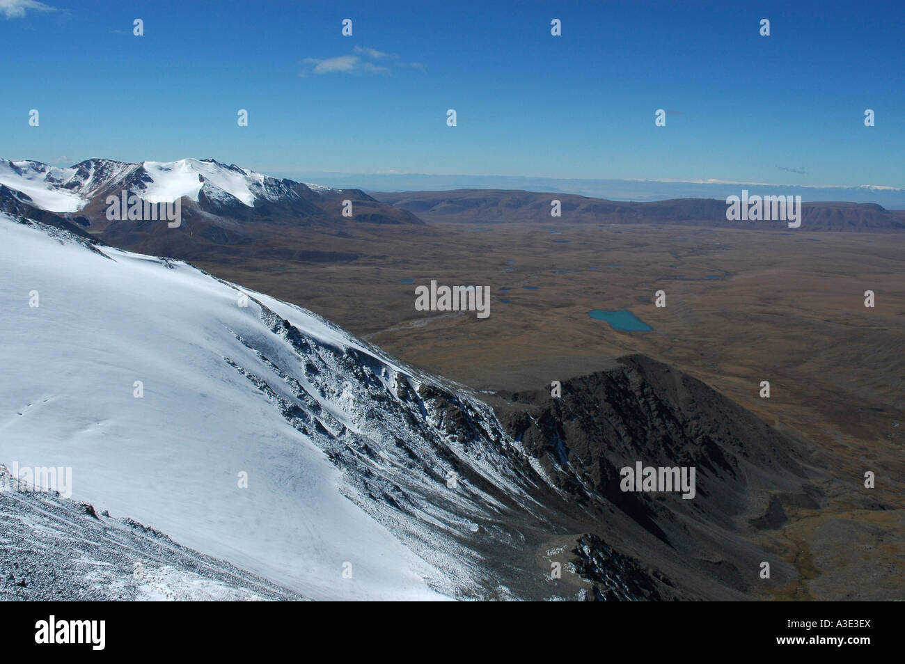 Snow covered mountain chain with wide open steppe Kharkhiraa Mongolian ...