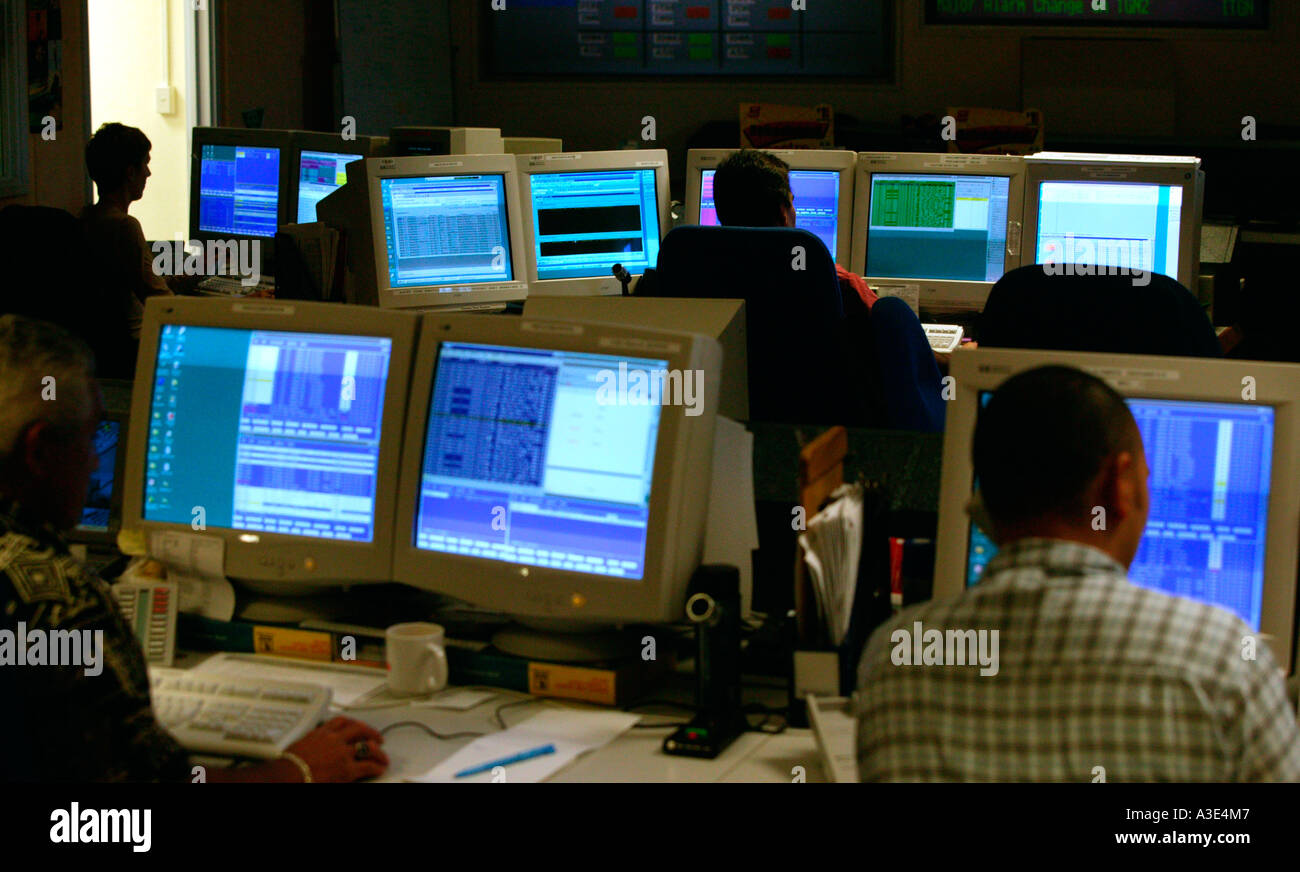 Computer room, 4 people looking at screens Stock Photo - Alamy