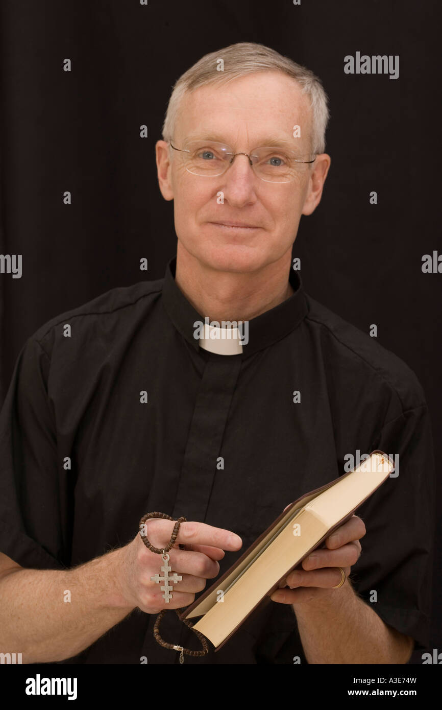 A portrait of a priest holding a bible. This priest is played by a ...