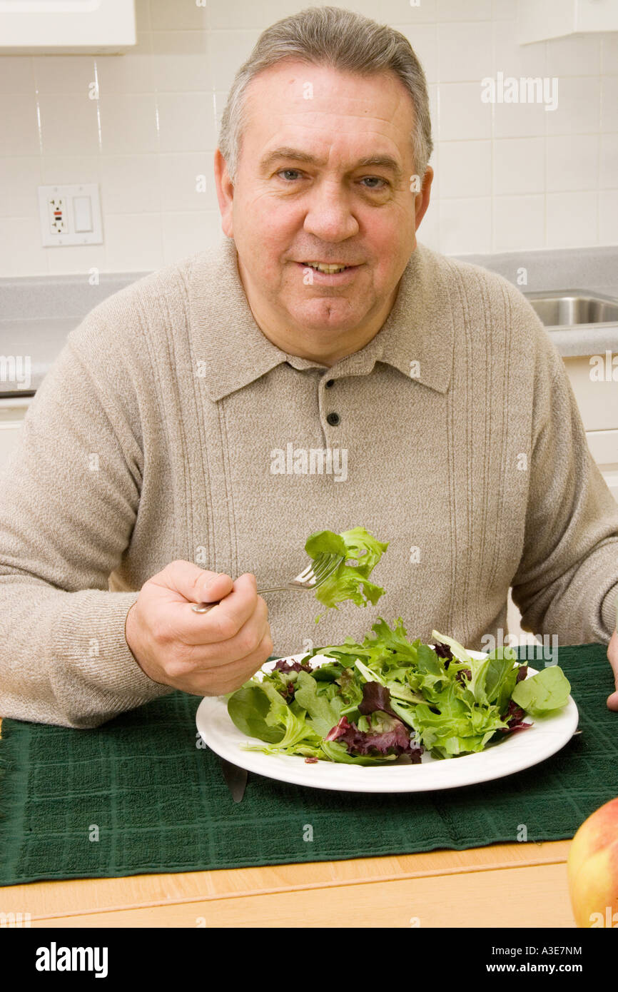 Man eating a healthy salad Stock Photo - Alamy