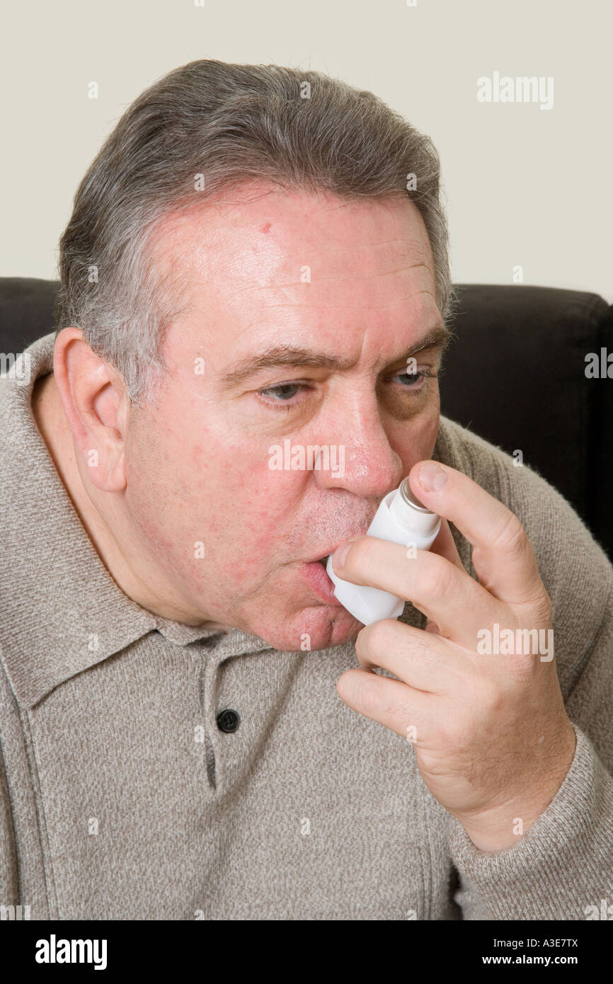 Asthmatic patient uses an inhaler to breathe better after an asthma ...