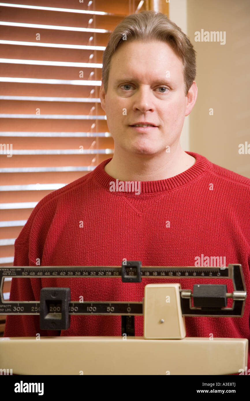 Man at doctor being weighed hi-res stock photography and images - Alamy