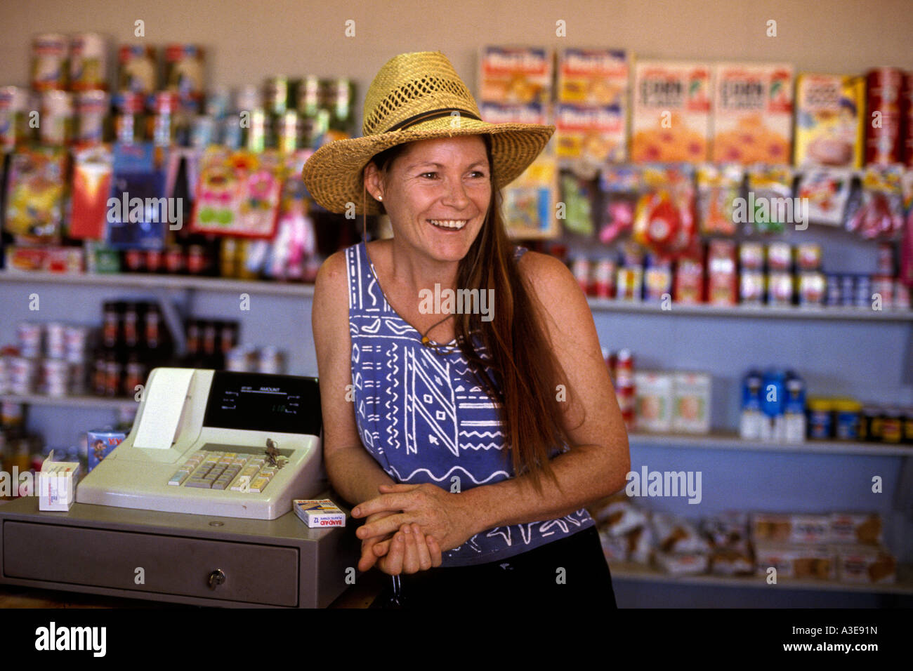 Woman at homestead store selling supplies to local aboriginal community ...