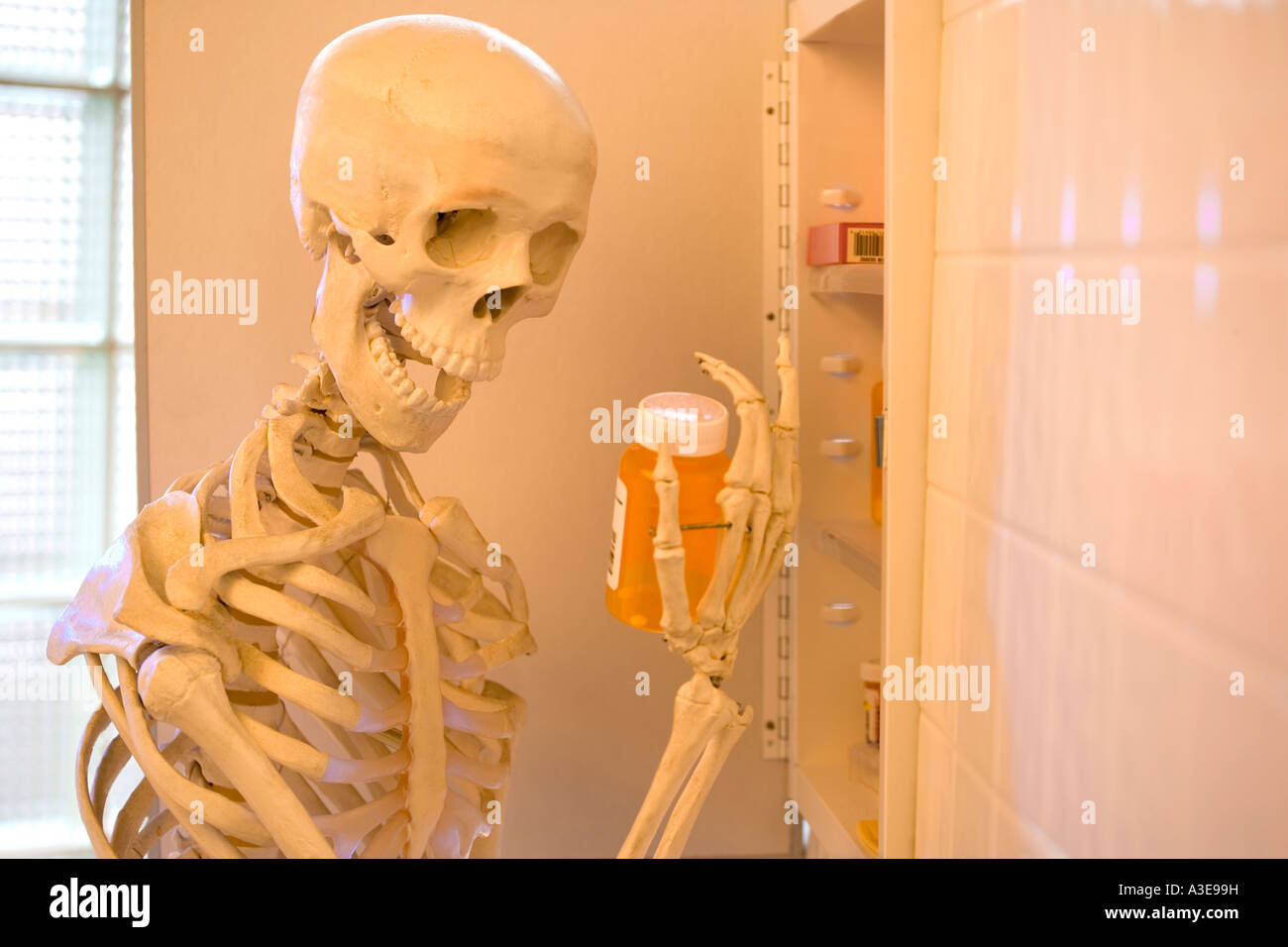 Skeleton takes drugs from the medicine cabinet. Spooky Stock Photo - Alamy