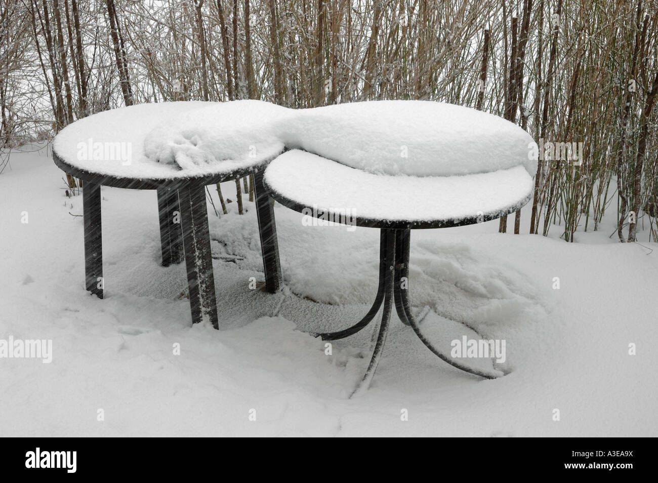 Snow covered tables Stock Photo - Alamy