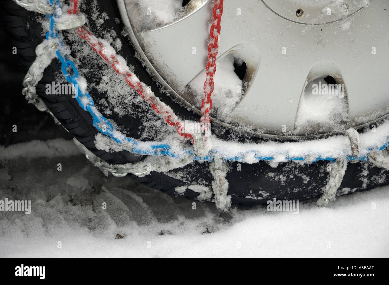 Car tire with snow chain Stock Photo - Alamy