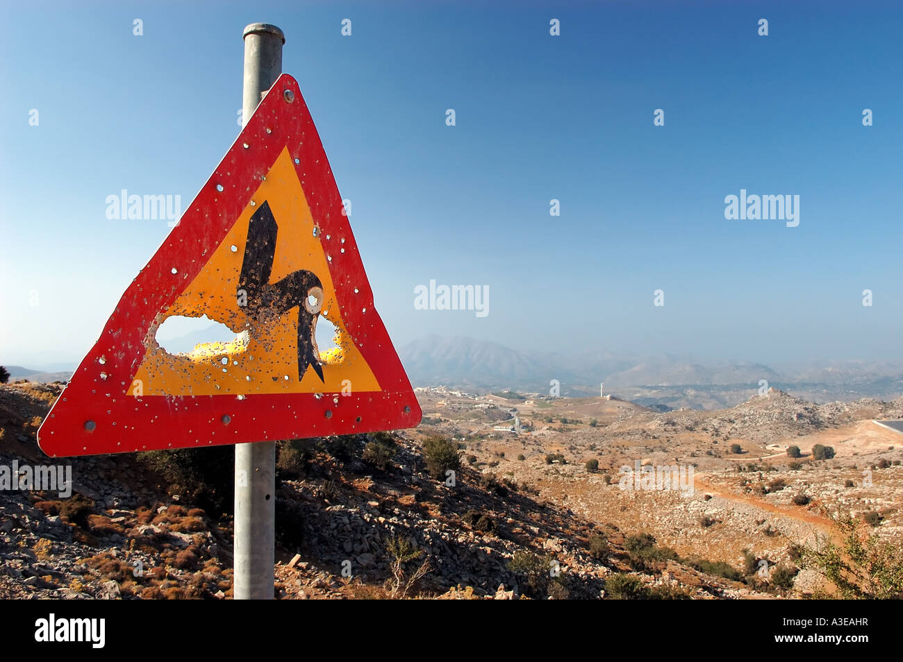 Shoted up road sign in the mountains of Crete, Grece Stock Photo - Alamy