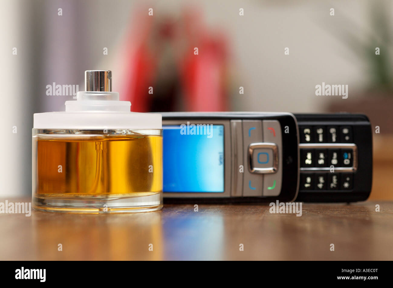 Mobile phone and perfume on kitchen table Stock Photo - Alamy