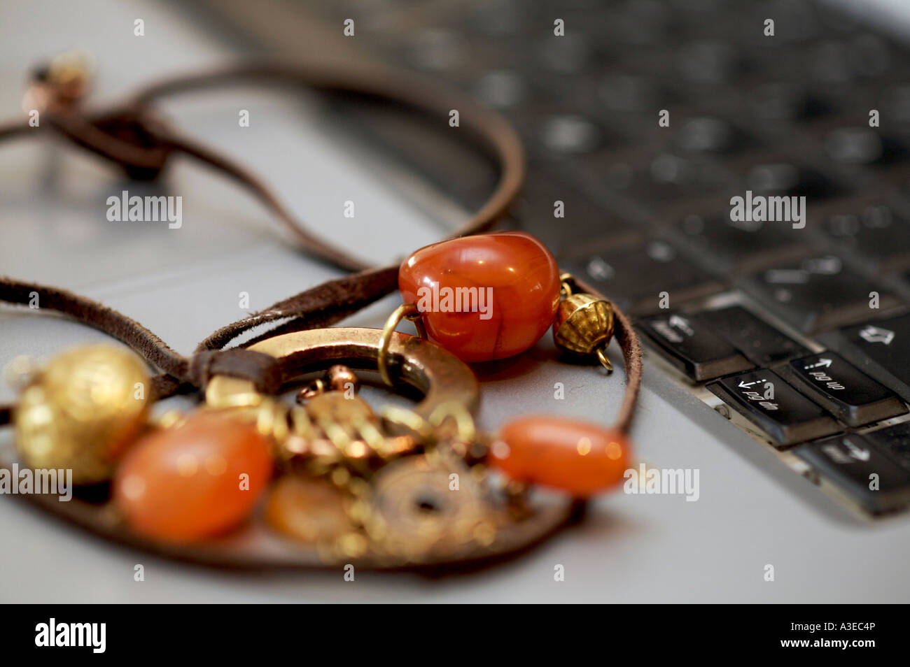 Jewelry resting on a computer keyboard Stock Photo - Alamy