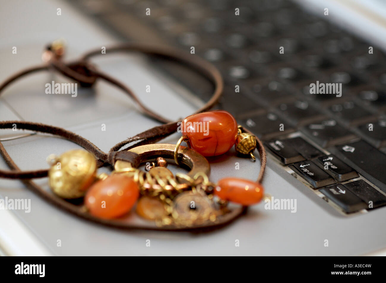 Jewelry resting on a computer keyboard Stock Photo - Alamy