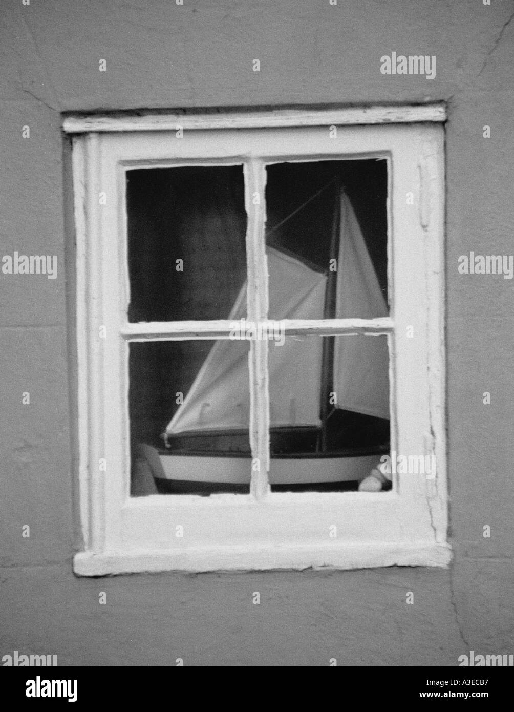 Model boat in off centre window Stock Photo - Alamy