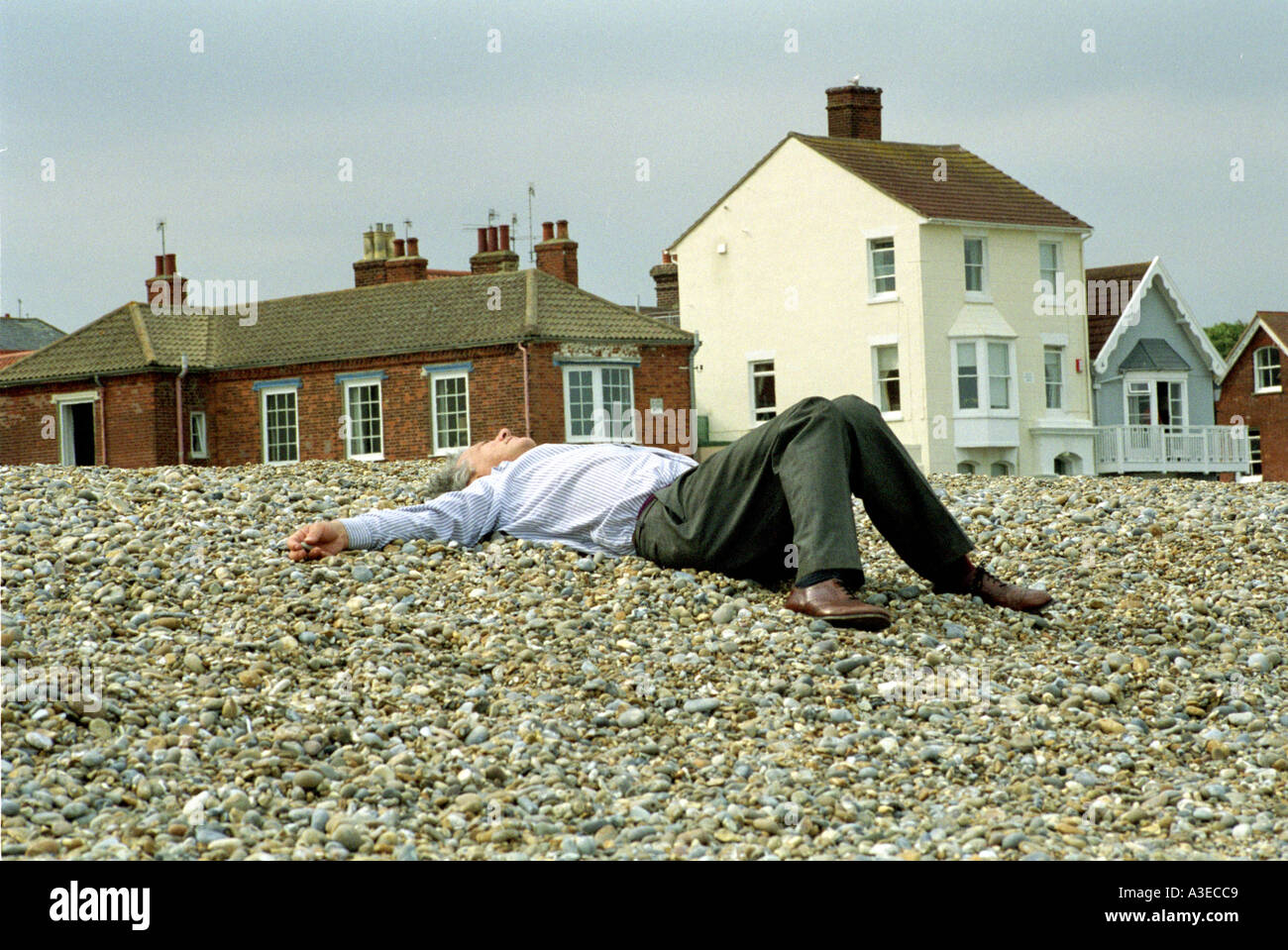 Too Hard Tired man stretched out on beach Stock Photo - Alamy