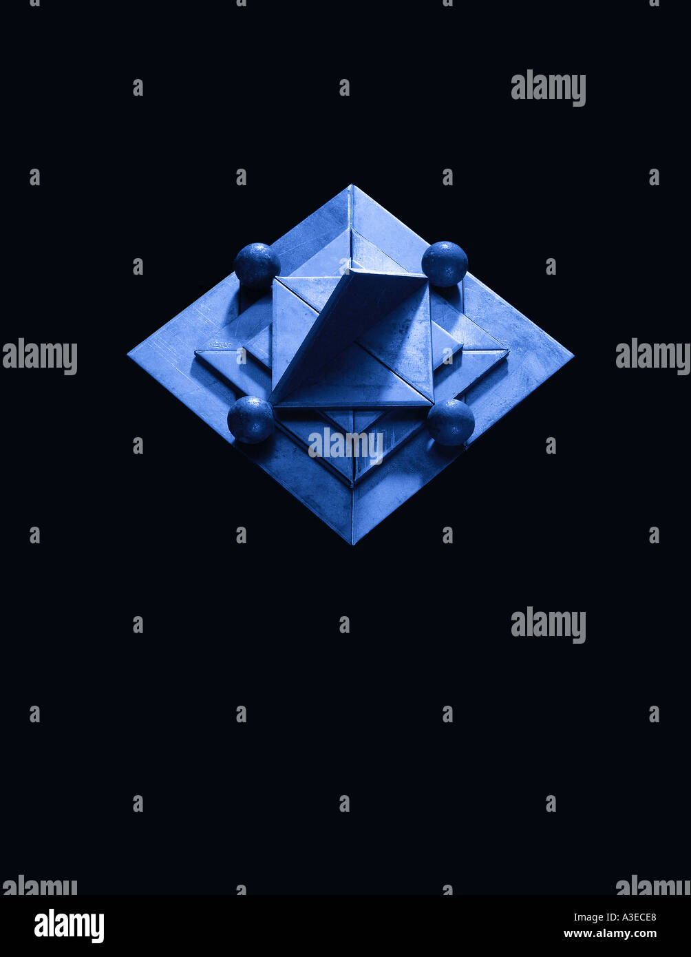 Abstract geometric still life of weathered steel balls and triangular ...