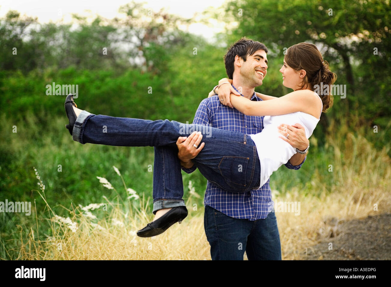 Man carrying woman Stock Photo - Alamy