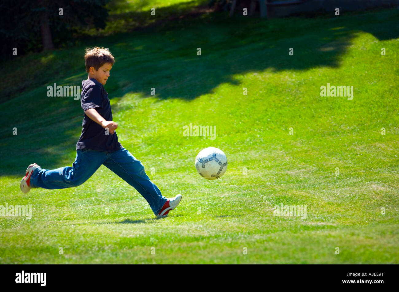 Boy playing soccer Stock Photo - Alamy