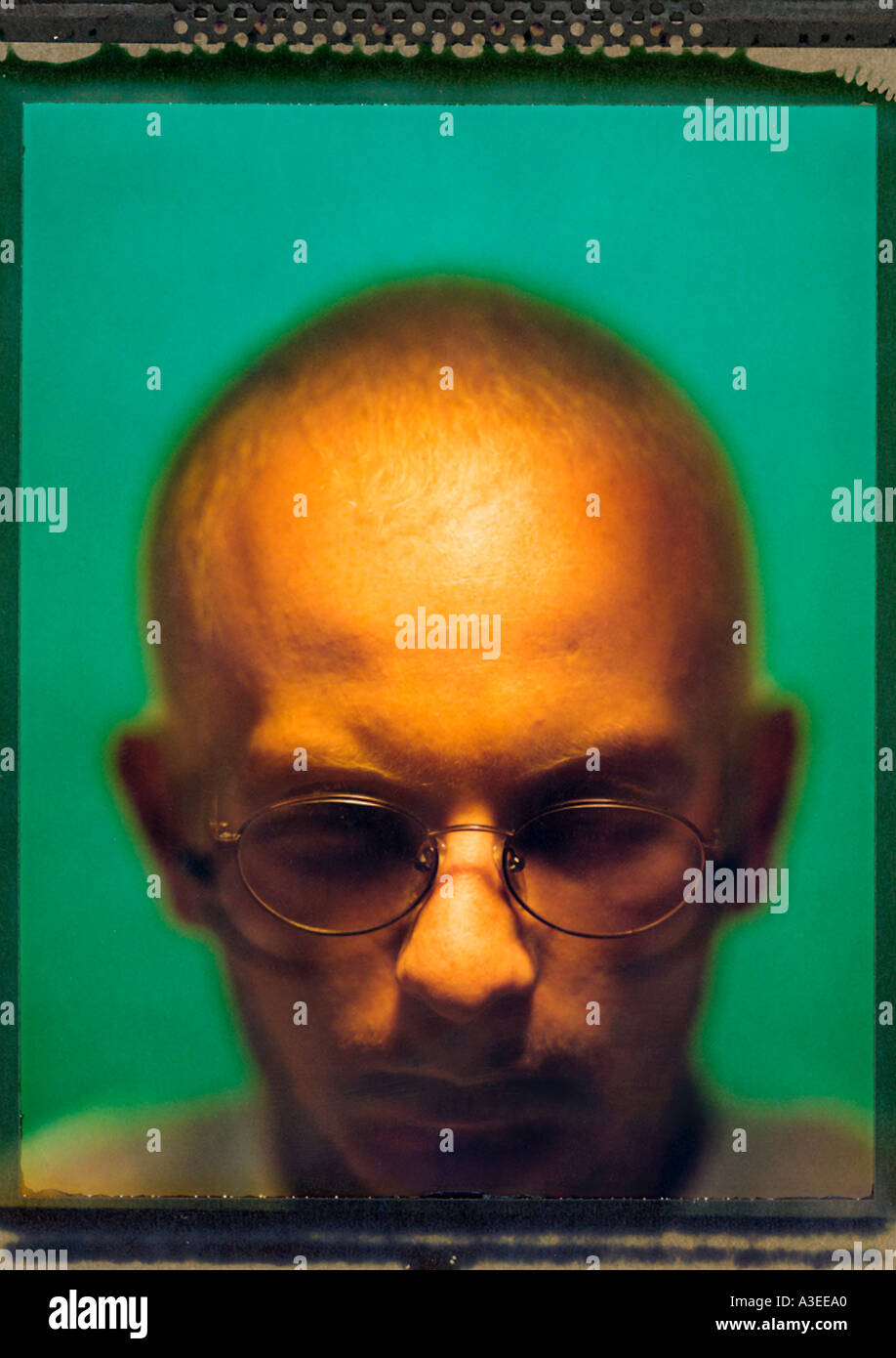 STRANGE DISTURBING MALE FACE ON GREEN BACKGROUND Stock Photo - Alamy