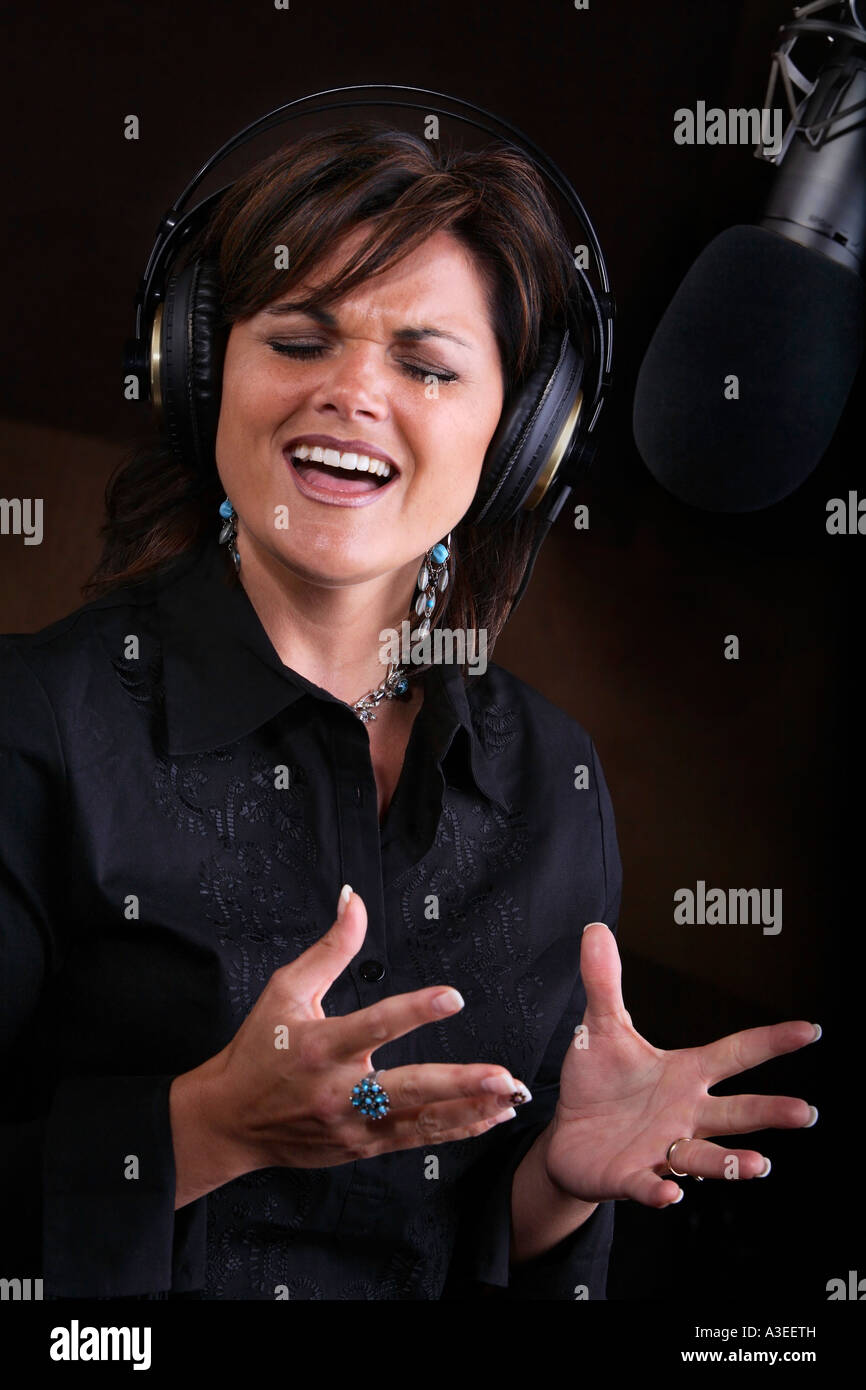 Woman singing in recording studio Stock Photo - Alamy