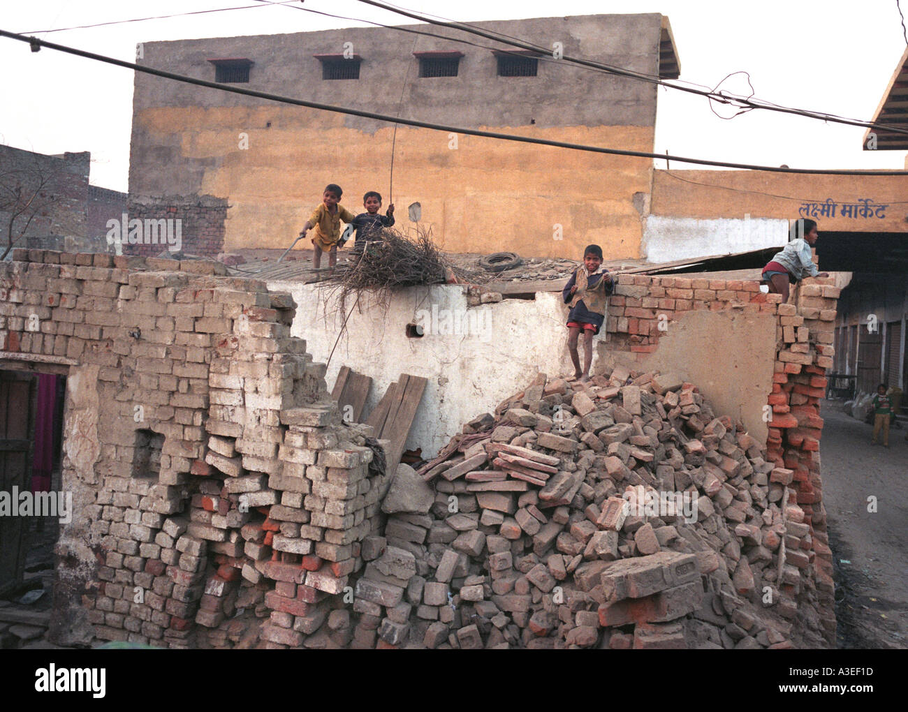 Young boys playing on the ruins of their home in Agra India Bricks and ...