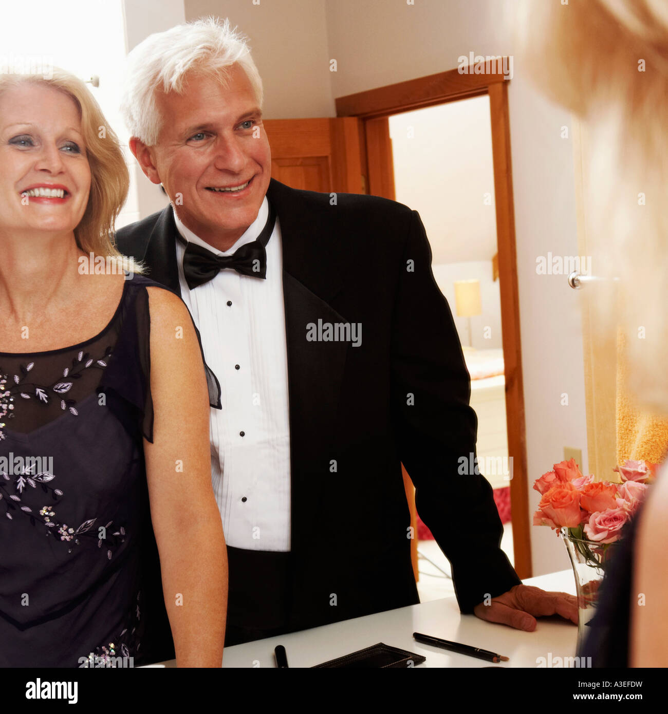Reflection of a mature couple smiling on a mirror Stock Photo - Alamy