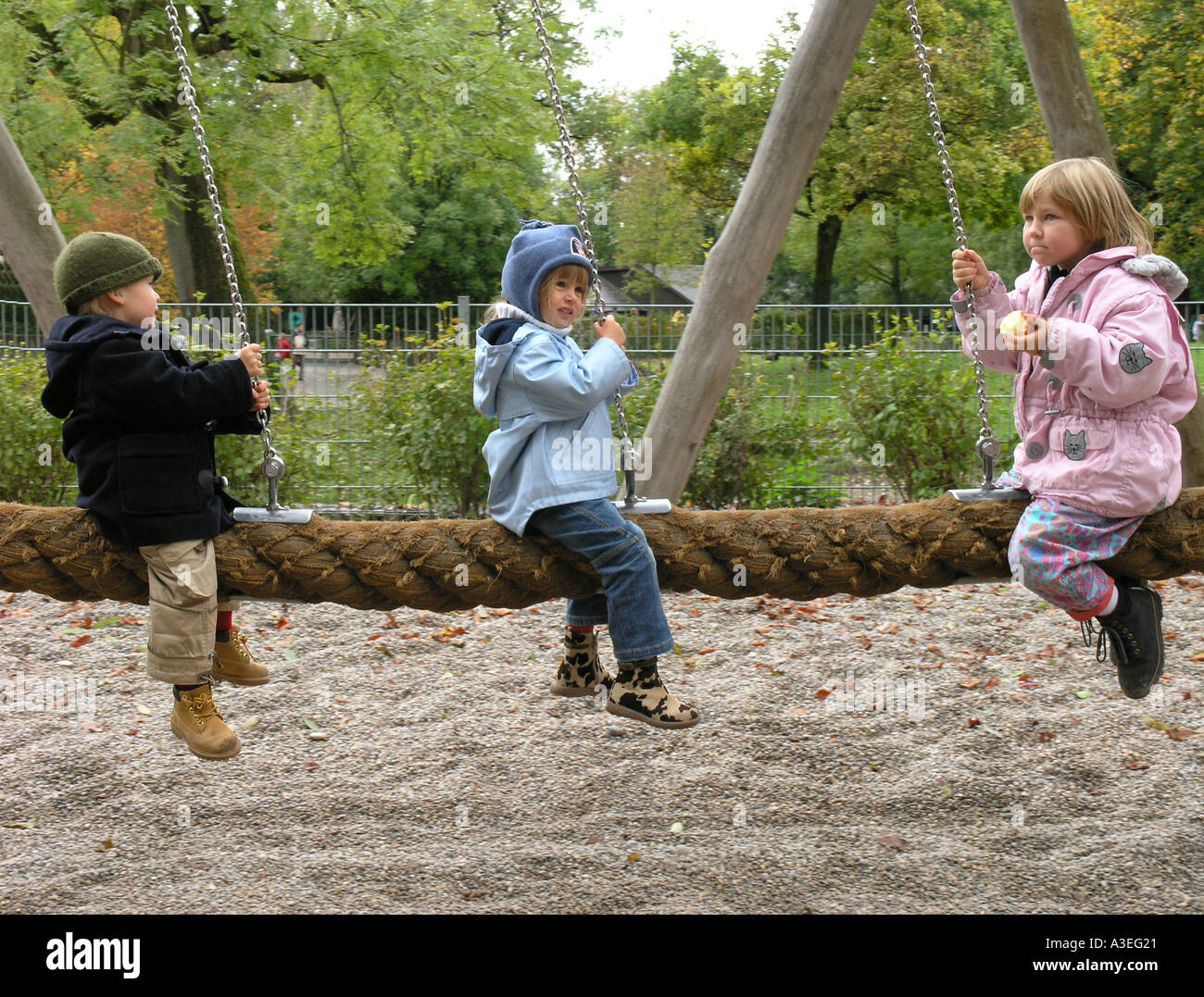 Kid children on balance pole swinging playground Stock Photo - Alamy