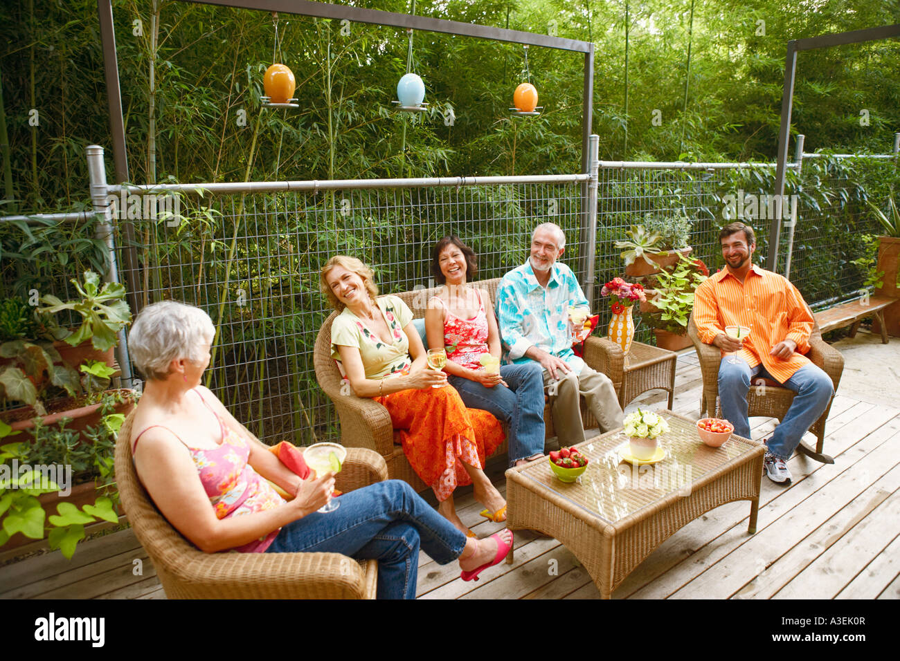 Five people sitting together and smiling Stock Photo - Alamy