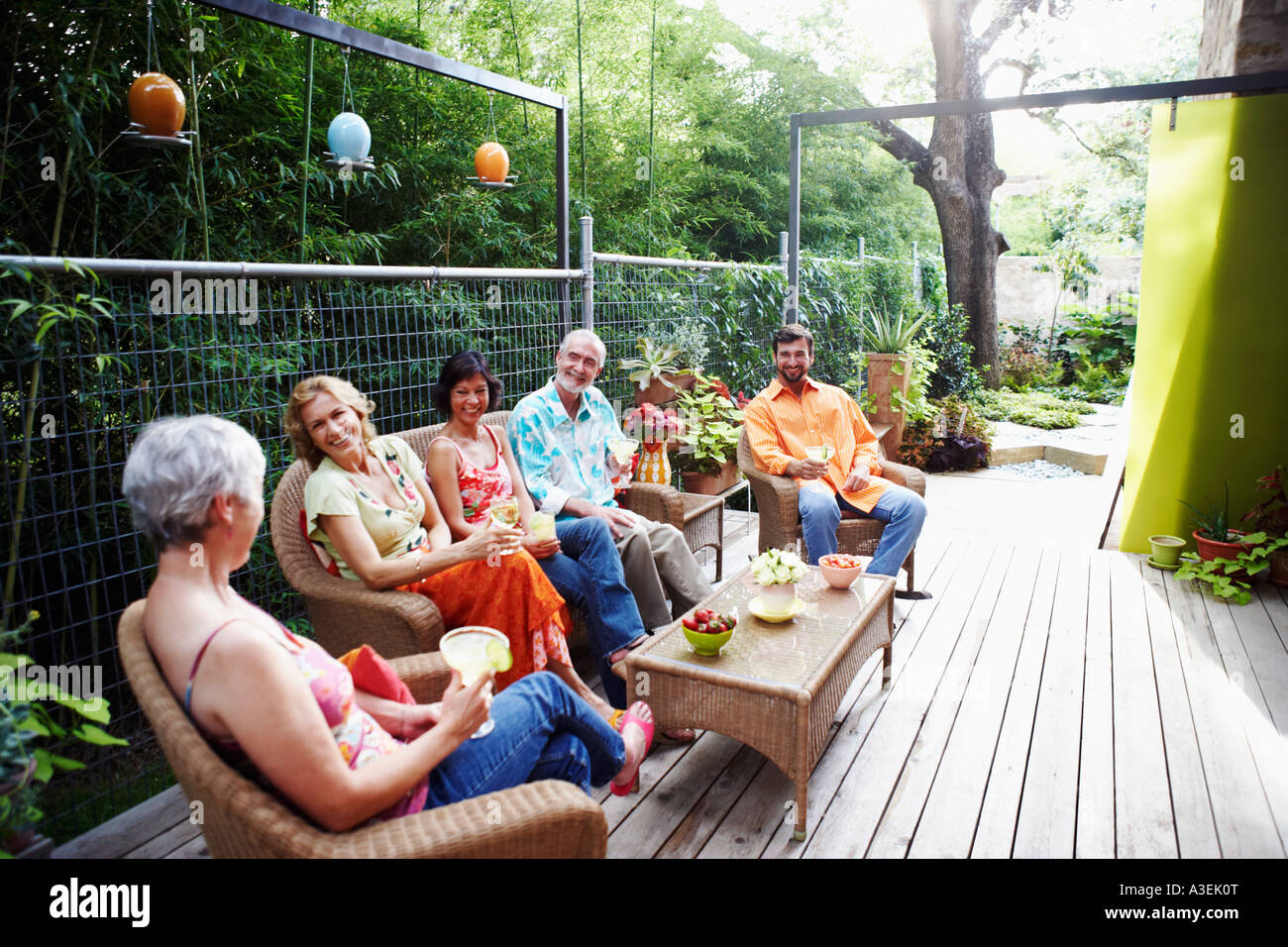 Five people sitting together and smiling Stock Photo - Alamy