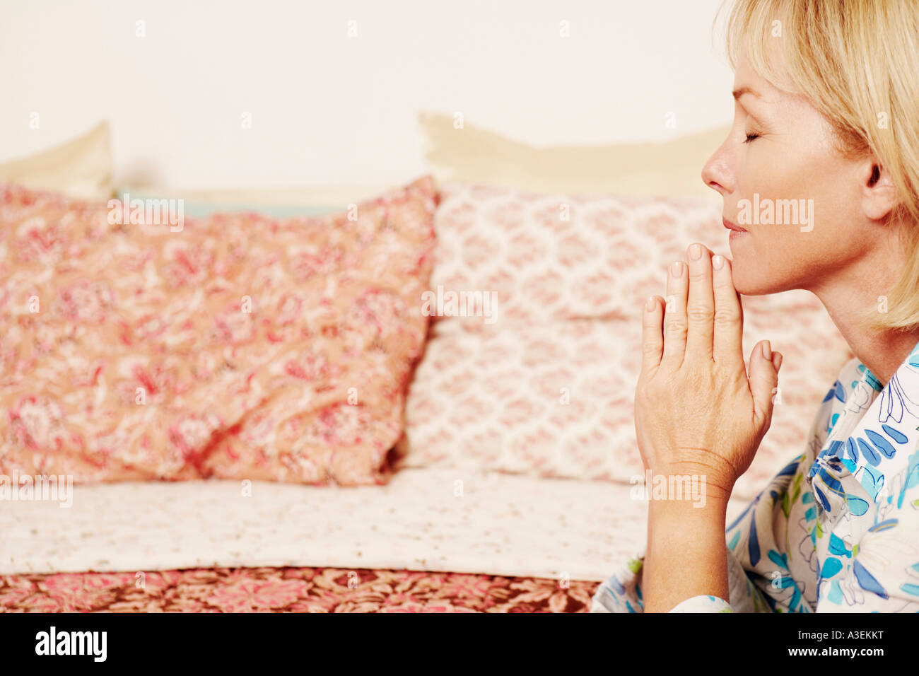 Side profile of a mature woman praying in a bedroom Stock Photo - Alamy