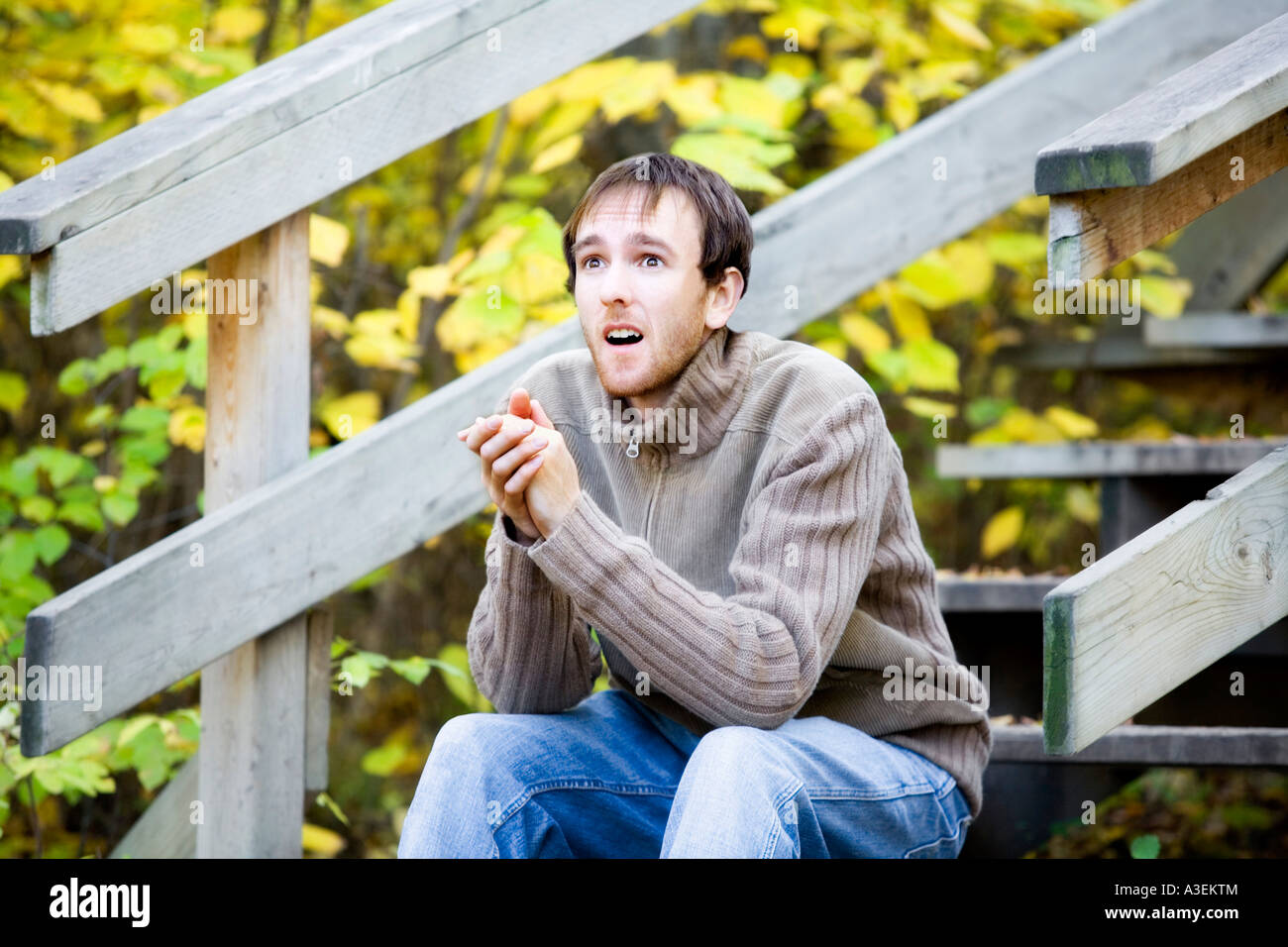 Man sitting on stairs Stock Photo - Alamy